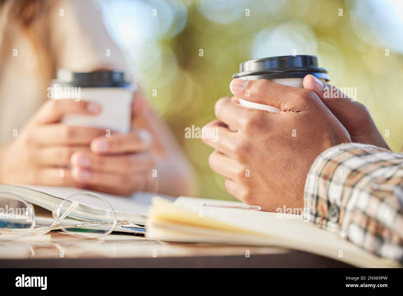 Couple, coffee and hands outdoor on a date while studying, together and ...