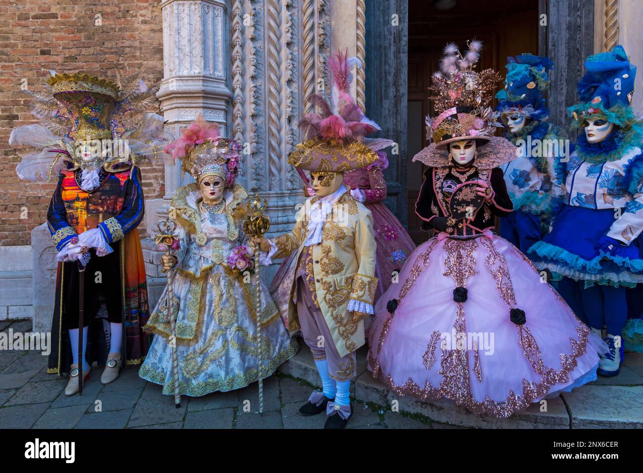 Carnival goers dressed in splendid costumes and masks during Venice ...