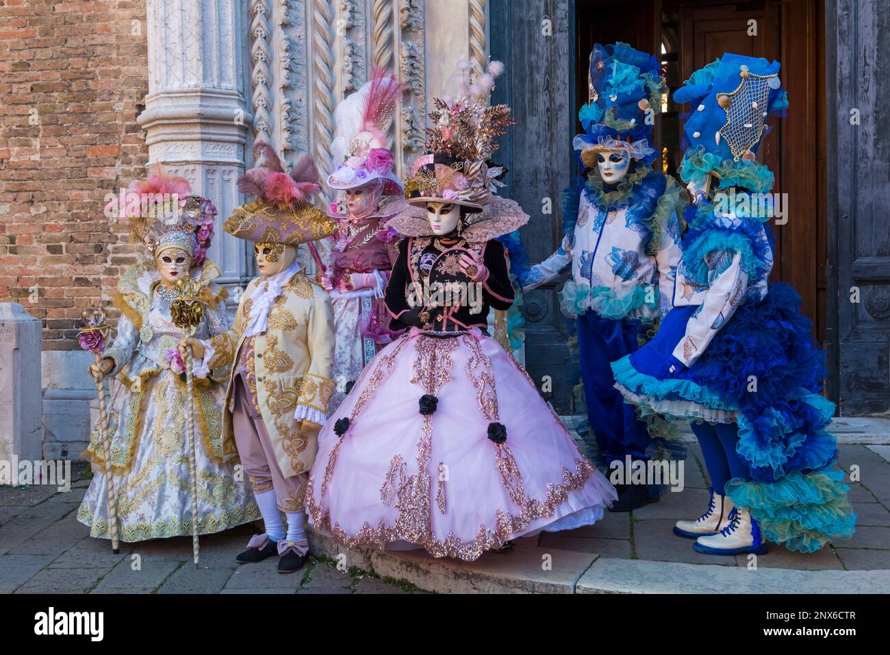 Carnival goers dressed in splendid costumes and masks during Venice ...