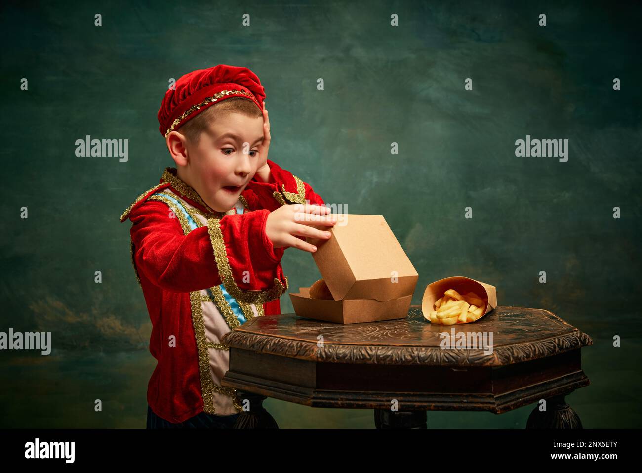 Happy cheerful little boy wearing costume of medieval page boy and ...
