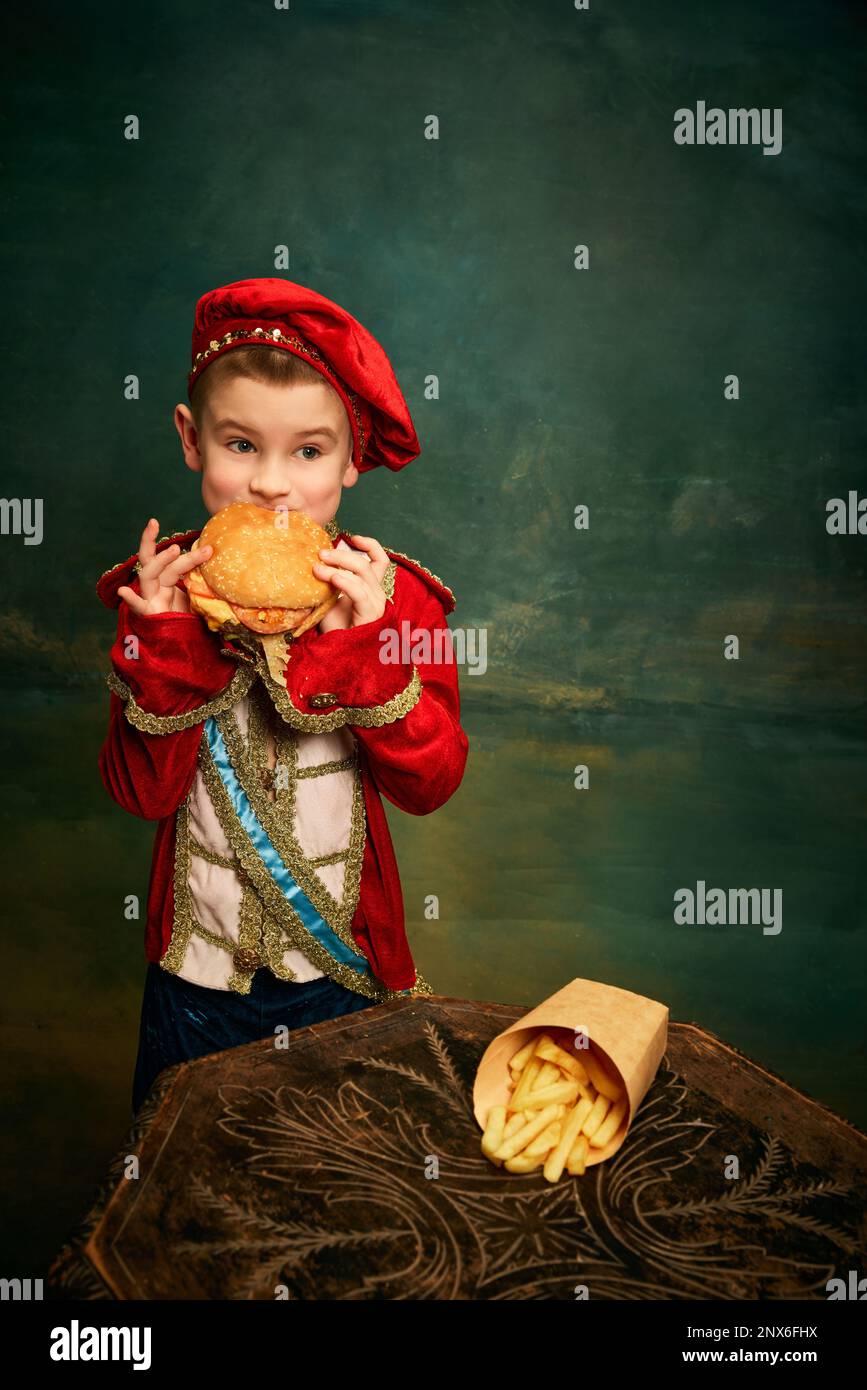 Happy cheerful little boy wearing costume of medieval page boy and ...