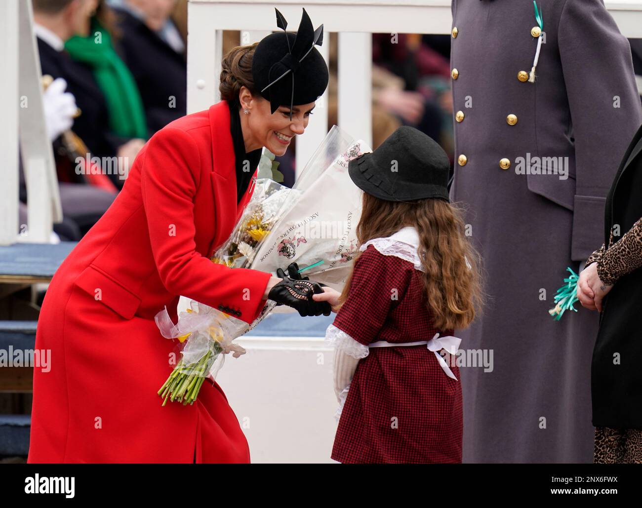 The Princess of Wales is presented with a bouquet of flowers by a young ...