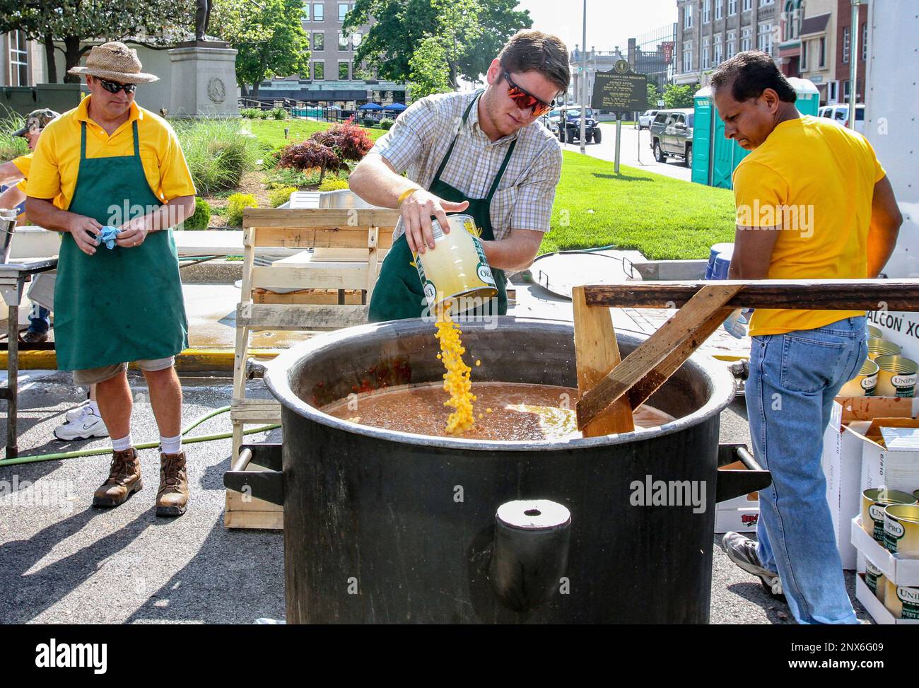 Drake Nonweiler adds corn to a kettle of burgoo as Barry Hardy, left ...