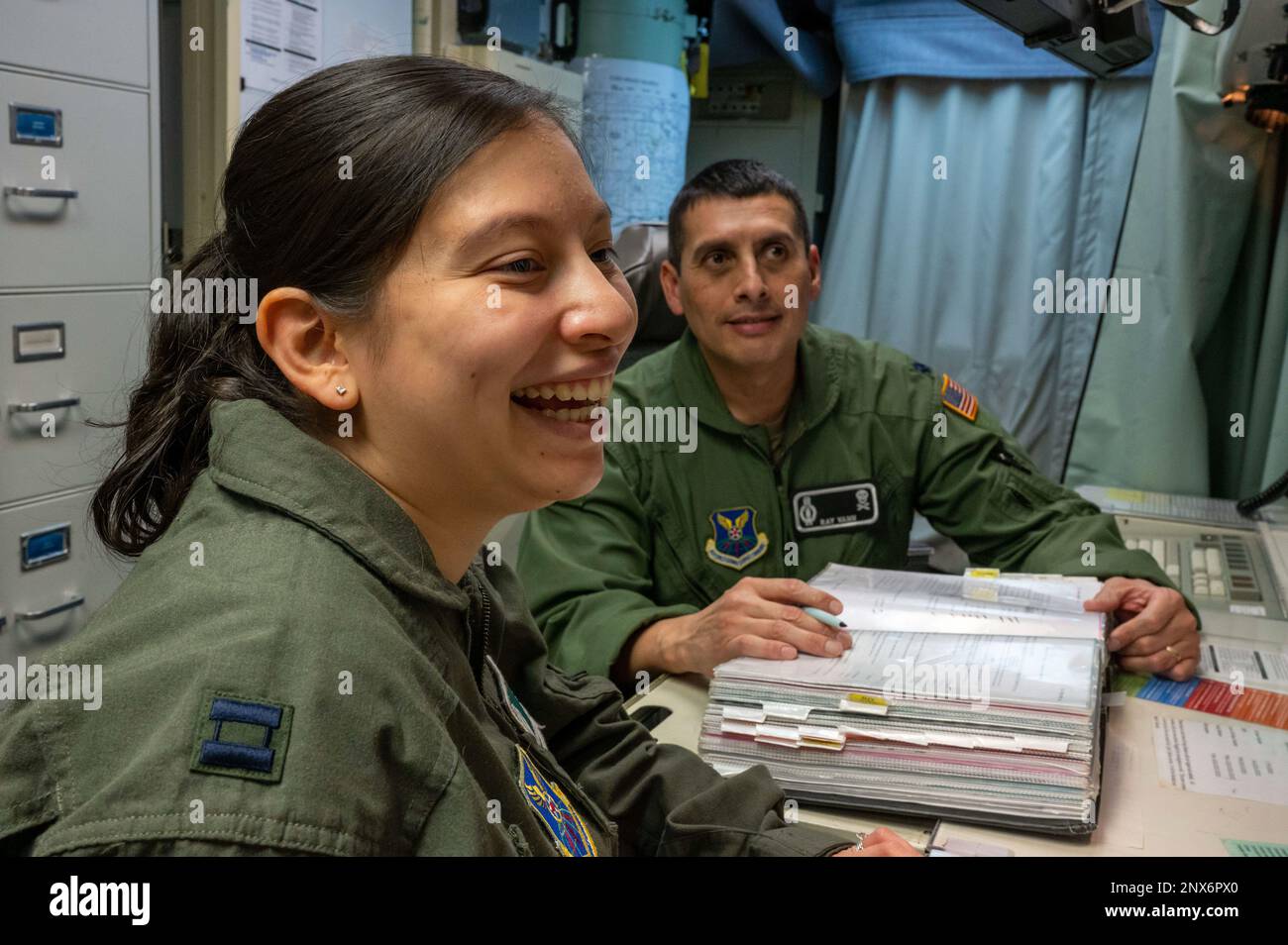 Lt. Col. Raymundo Vann tells a joke to Capt. Gabriella Graham while ...