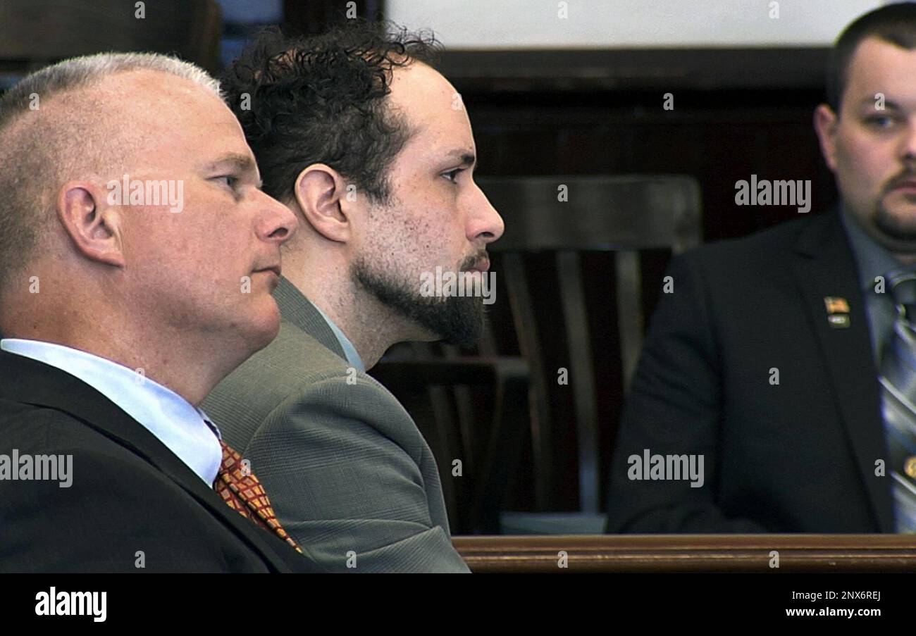 In this still image from video, Luc Tieman, center, and his lawyer ...