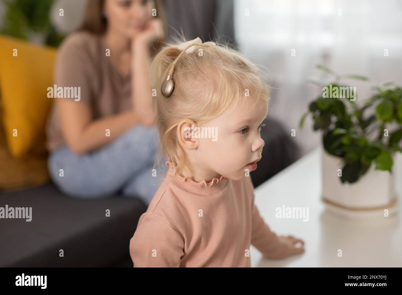 Cochlear implant system. Installation cochlear implant on child girl ...