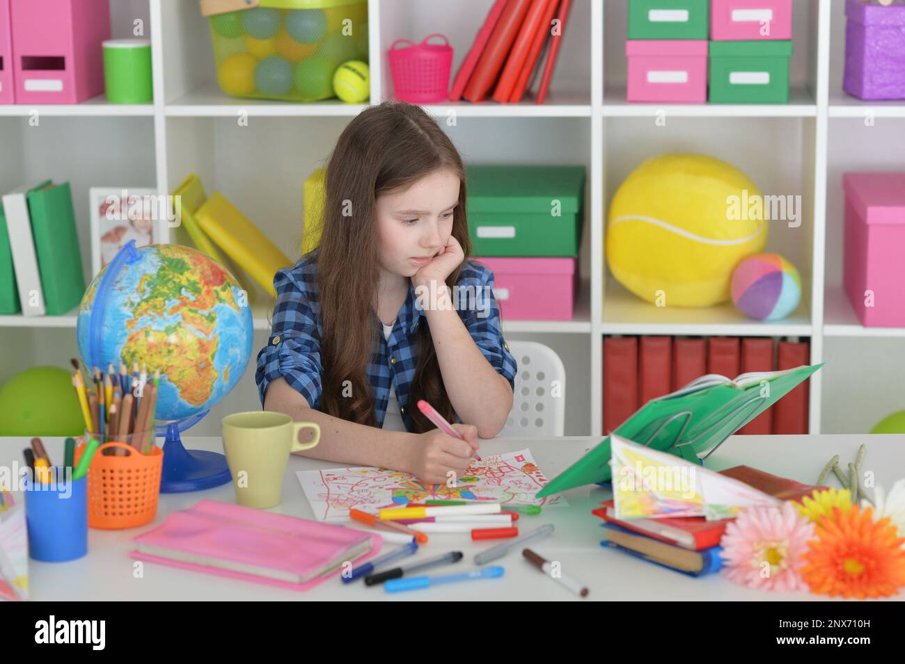 cute girl doing home work at desk Stock Photo - Alamy