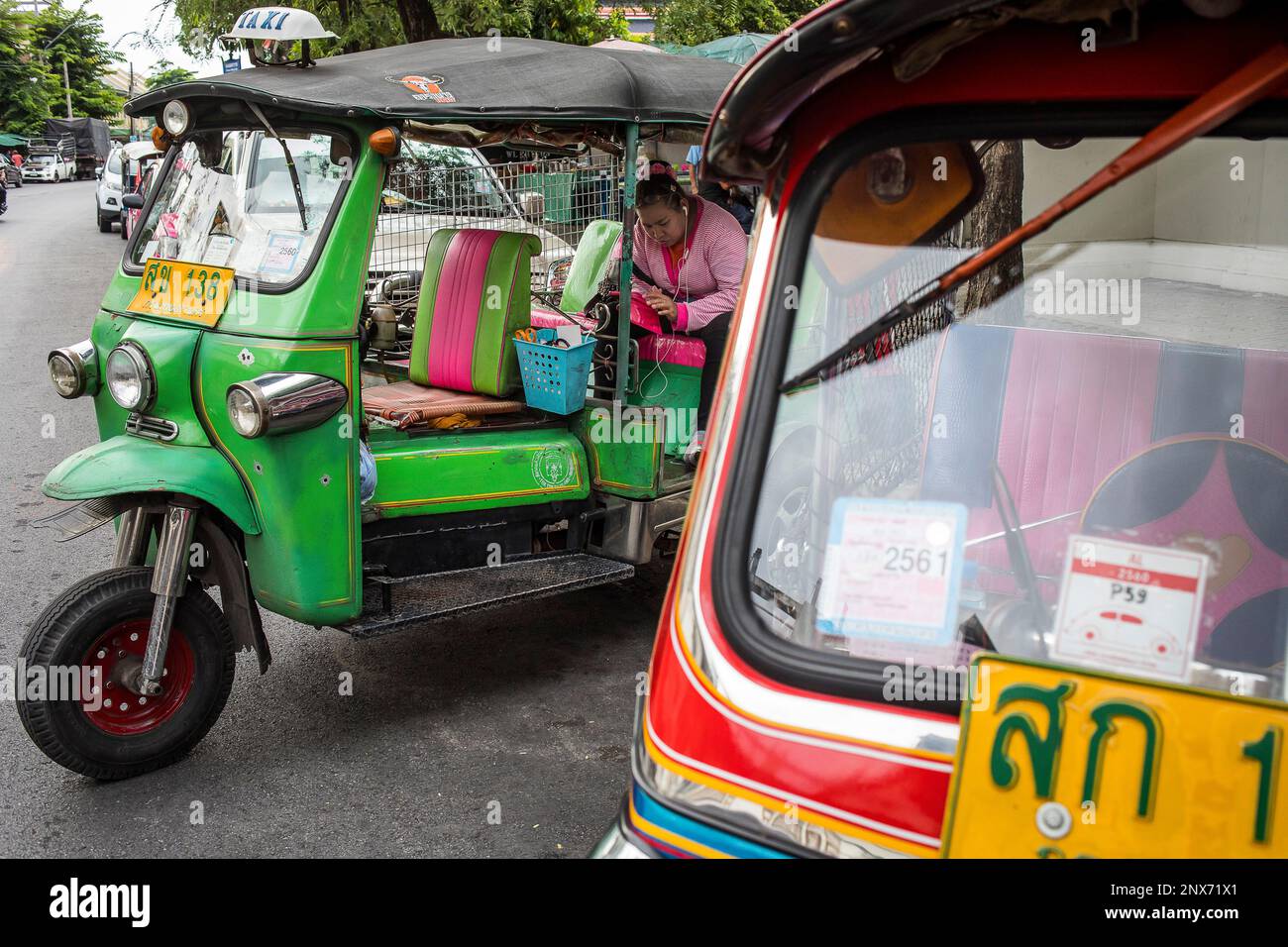 Woman,driver, waiting for customers, three wheel taxi Tuk Tuk, in Khao ...