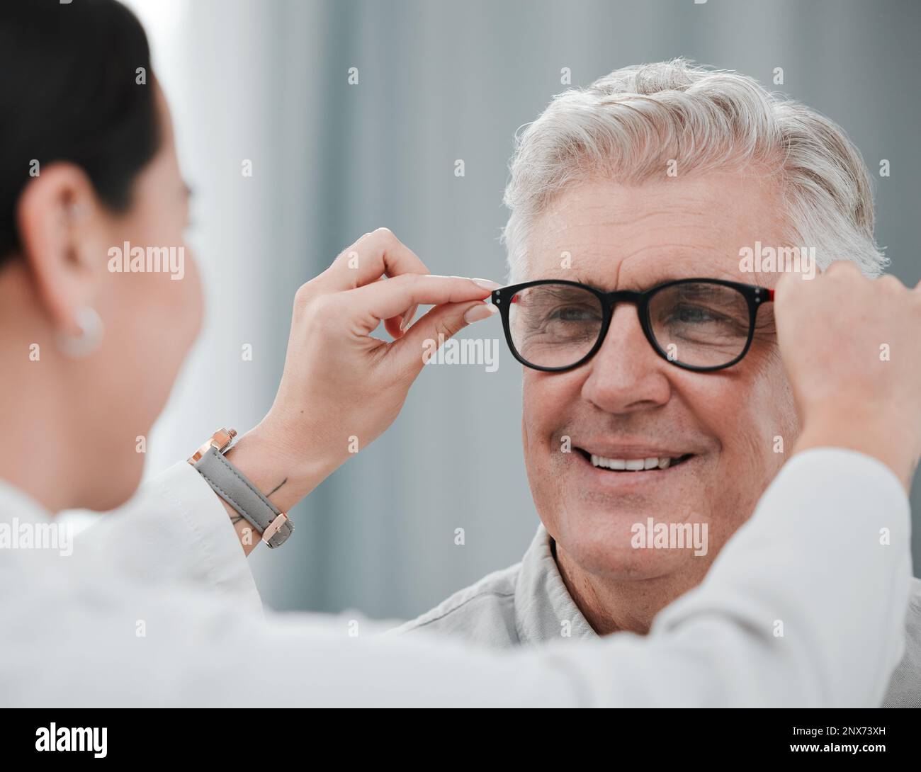 Optometry, ophthalmology and optometrist fitting glasses on senior man ...