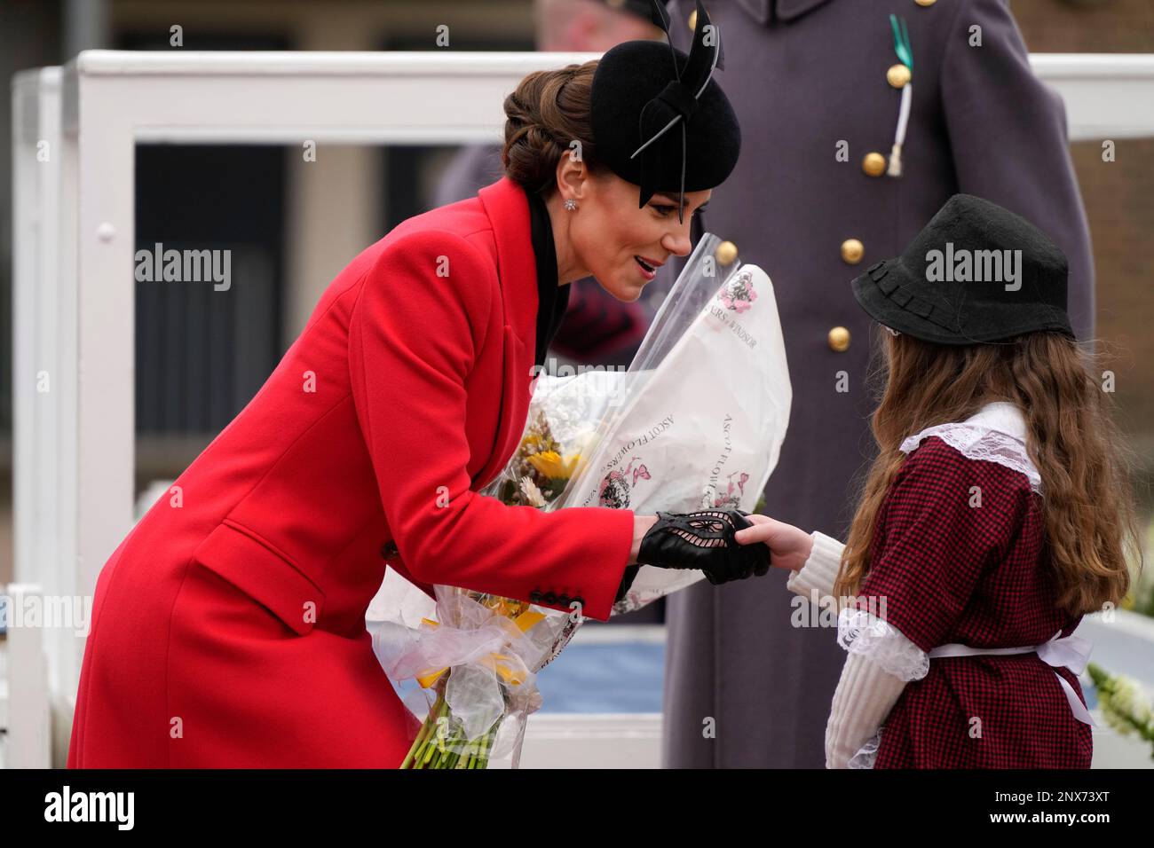 The Princess of Wales is presented with a bouquet of flowers by a young ...
