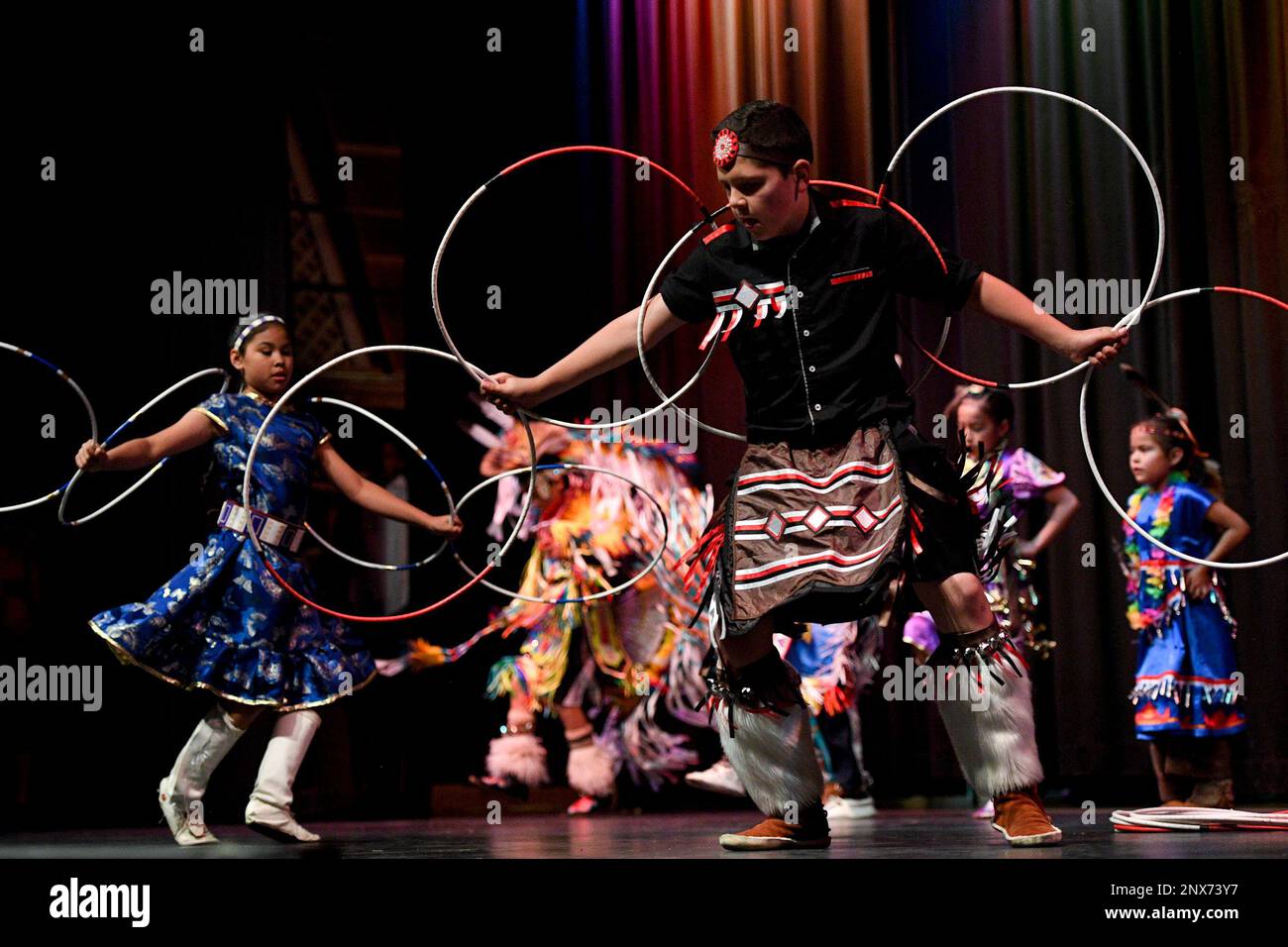 Dexter Clark performs a hoop dance in front of other students in the ...