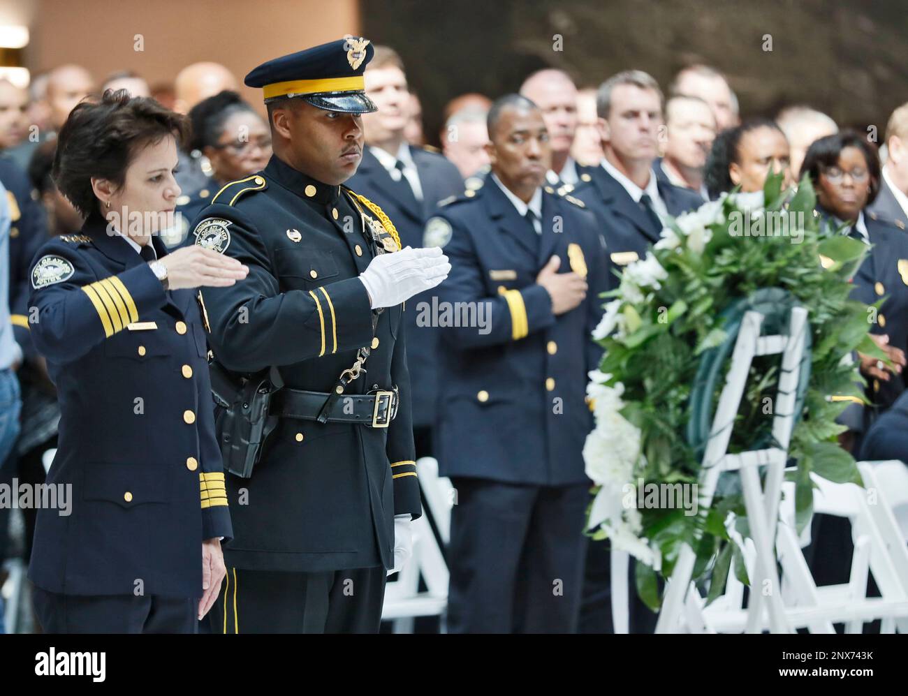 Atlanta Police Chief Erika Shields, left, and APD Honor Guard Officer Robert Livsey salute ...