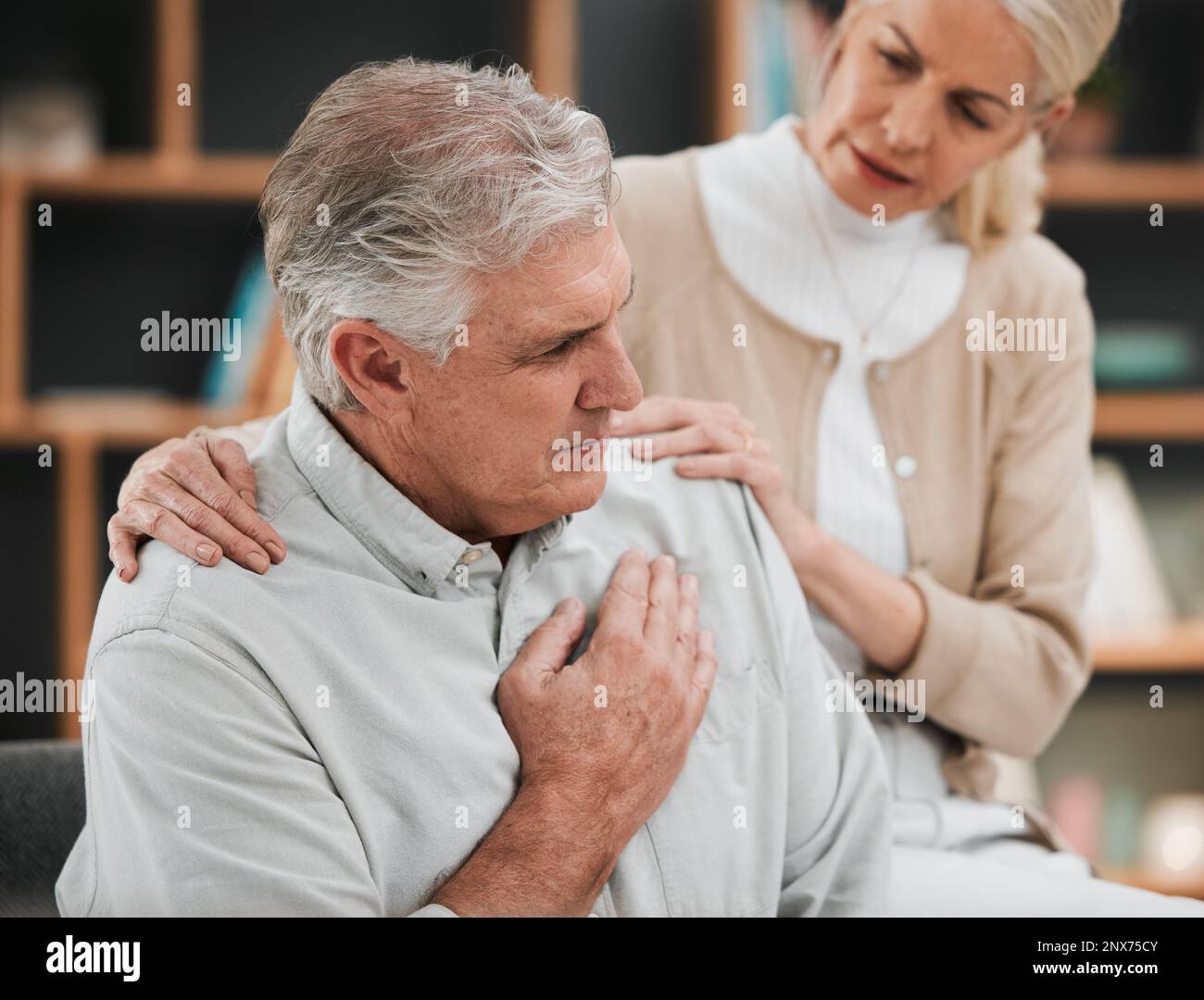 Heart attack, pain and senior couple at home with cardiology problem or ...