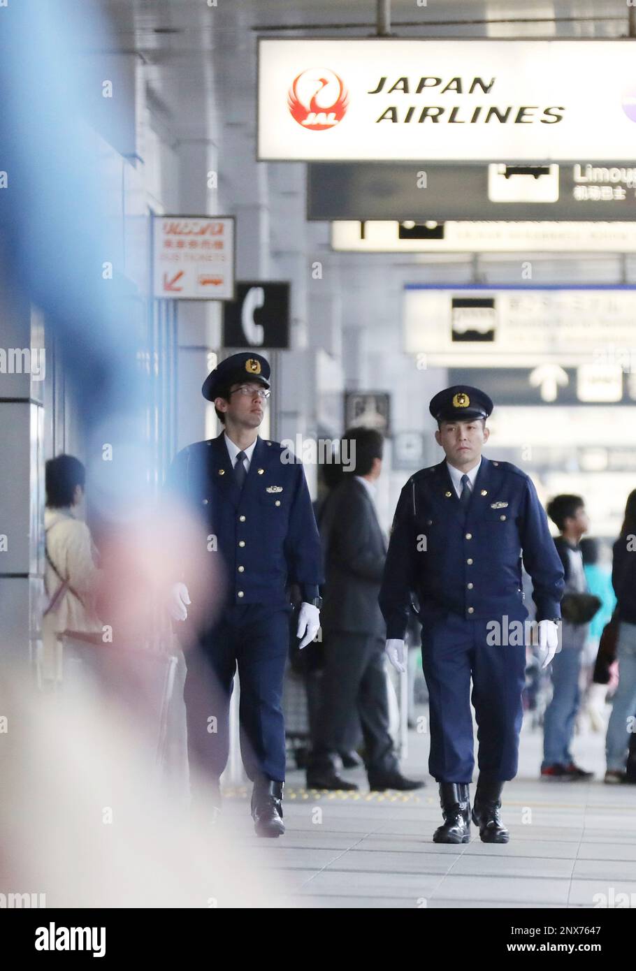 Riot police officers keep watch at Haneda International Airport in ...