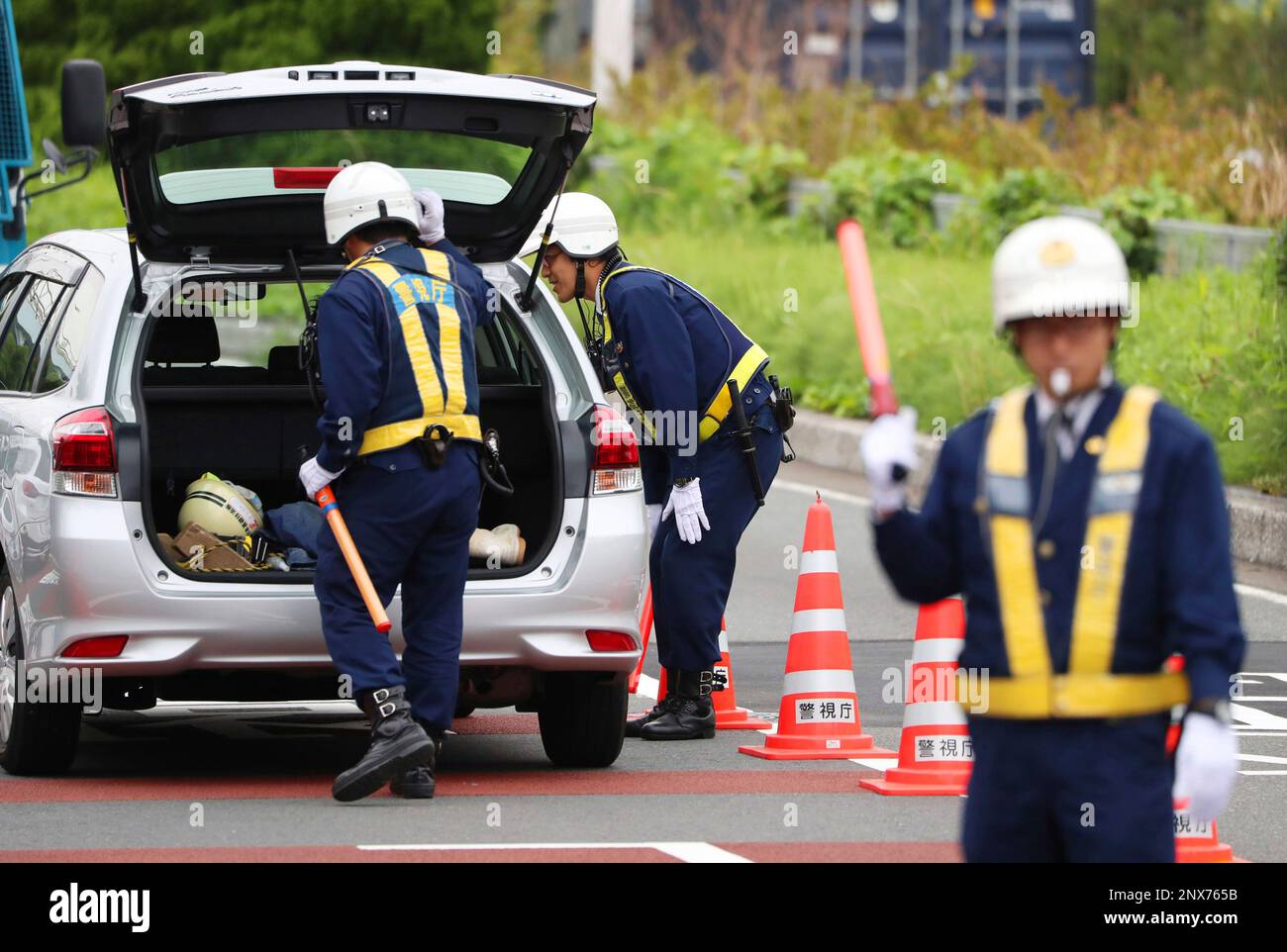 Riot police officers conduct a traffic check in Tokyo on May 8, 2018. A ...