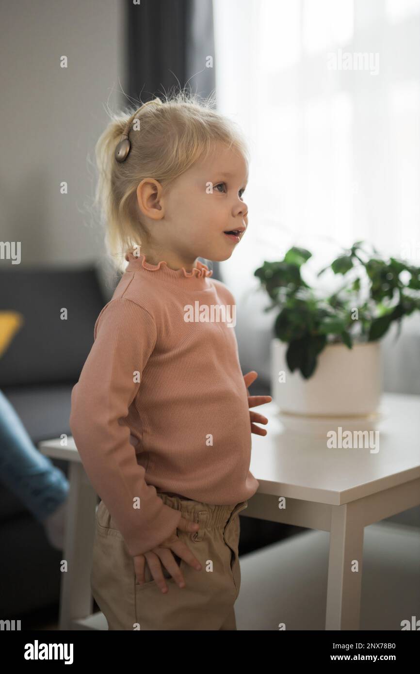 Cochlear implant system. Installation cochlear implant on child girl ...