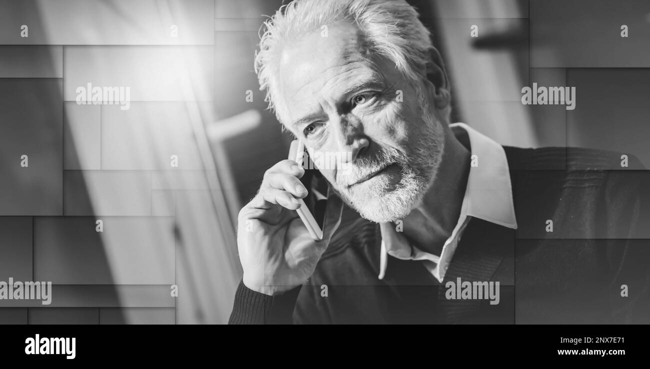 Portrait of senior modern man talking on mobile phone at home ...