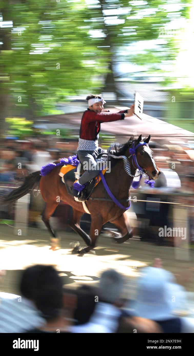 A man performs on a horse running in full speed during Kakeuma Shinji ...