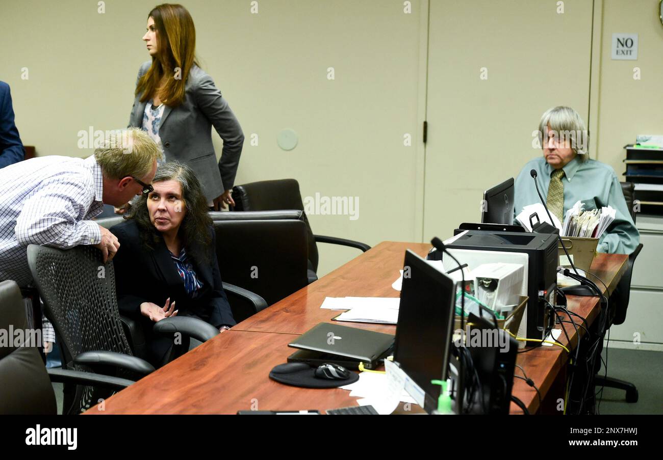 Defendant Louise Anna Turpin, second left, talks with an investigator ...