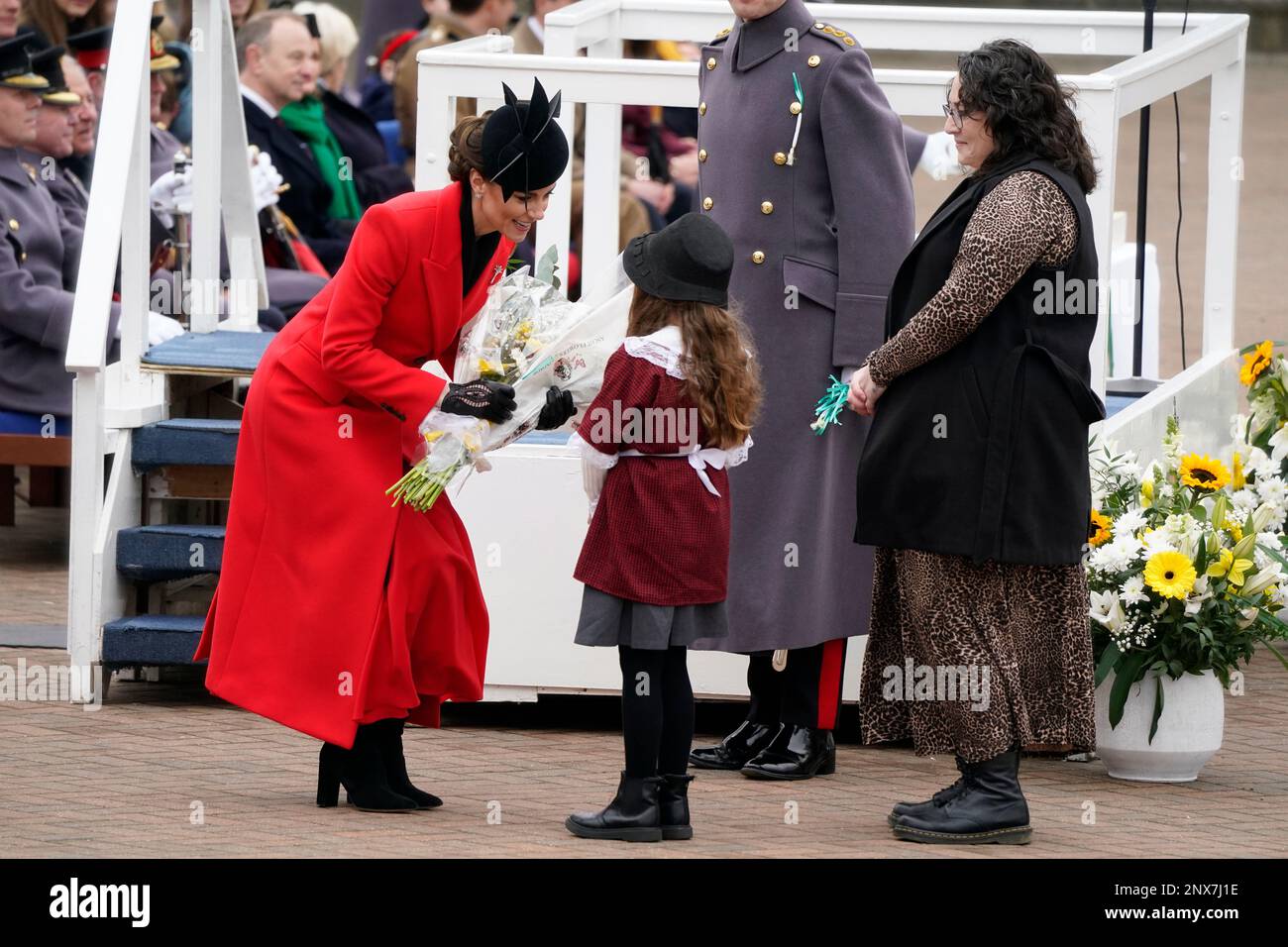 The Princess of Wales is presented with a bouquet of flowers by a young ...