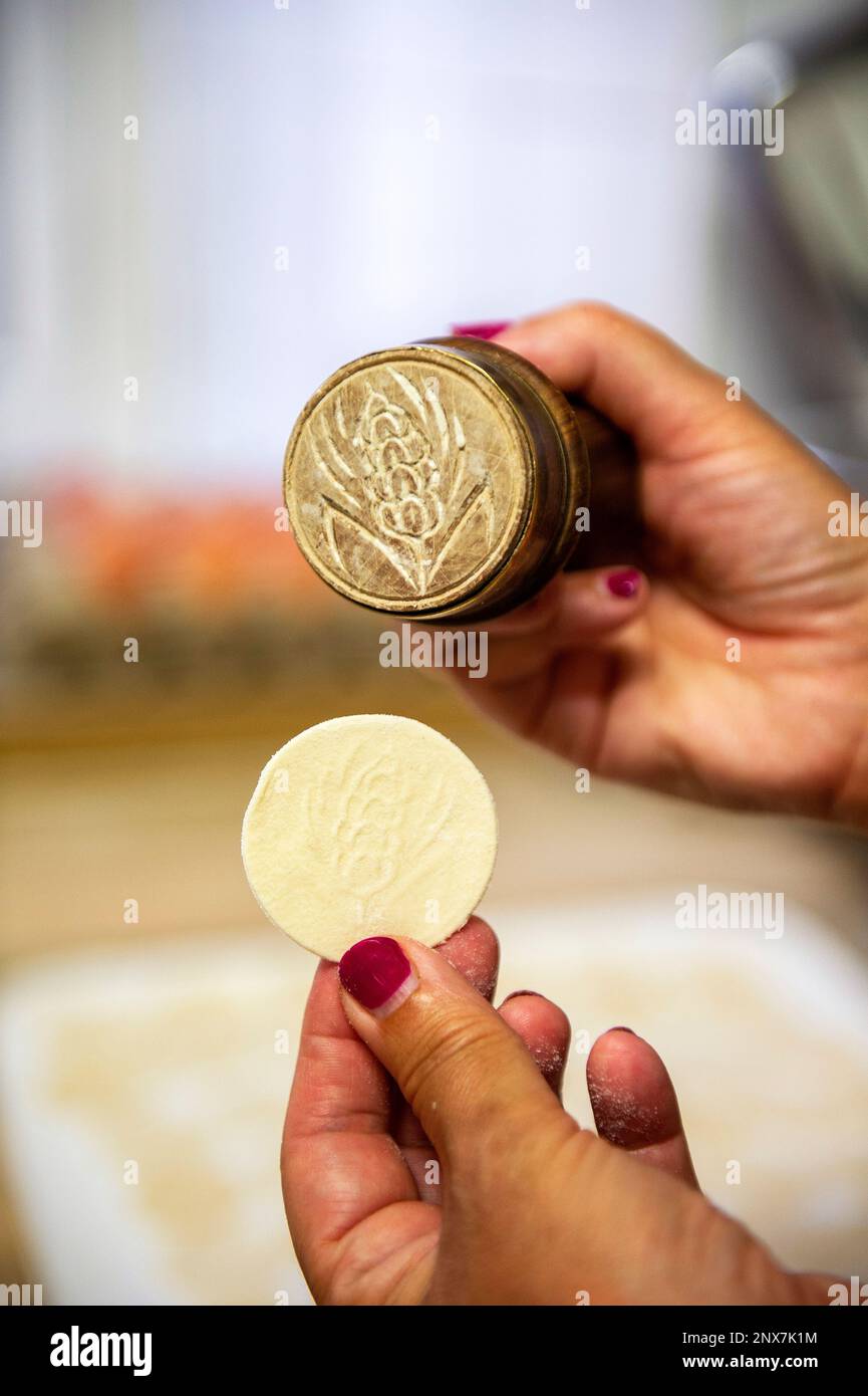 The making of traditional "Corzetti", a pasta typical from the Italian ...