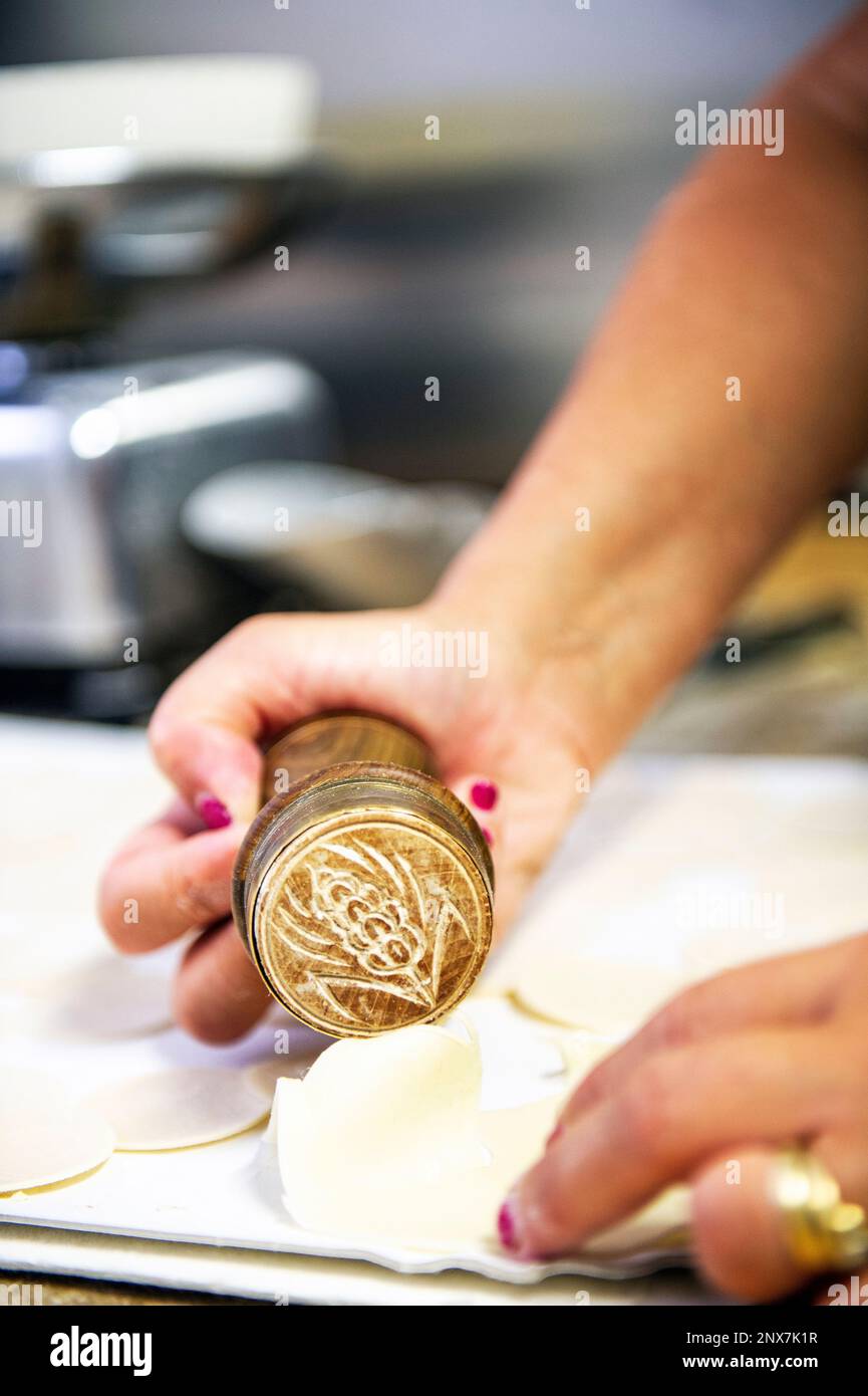 The making of traditional "Corzetti", a pasta typical from the Italian ...
