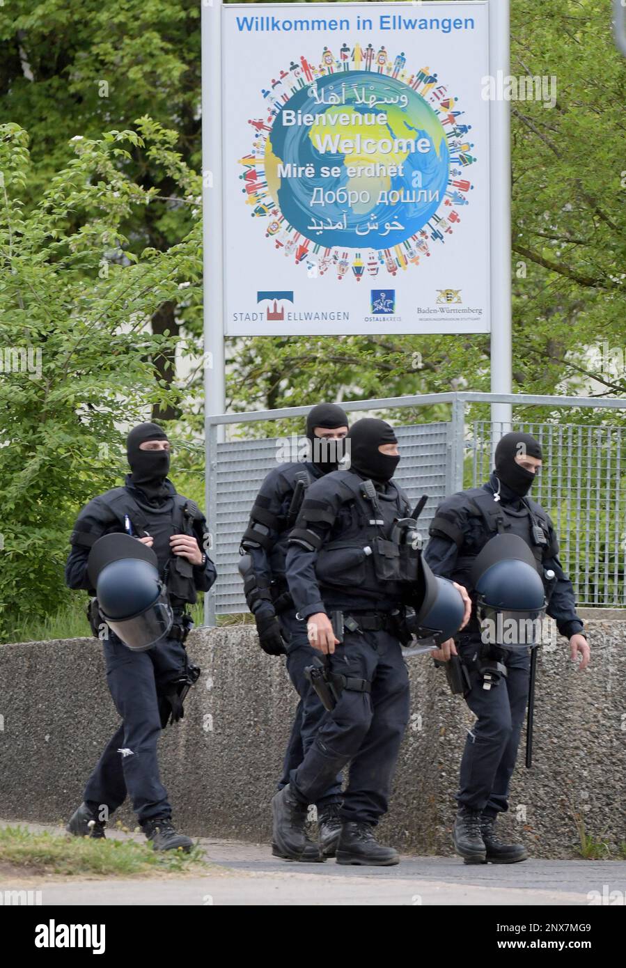 Masked police officers stand in a migrant shelter in Ellwangen ...