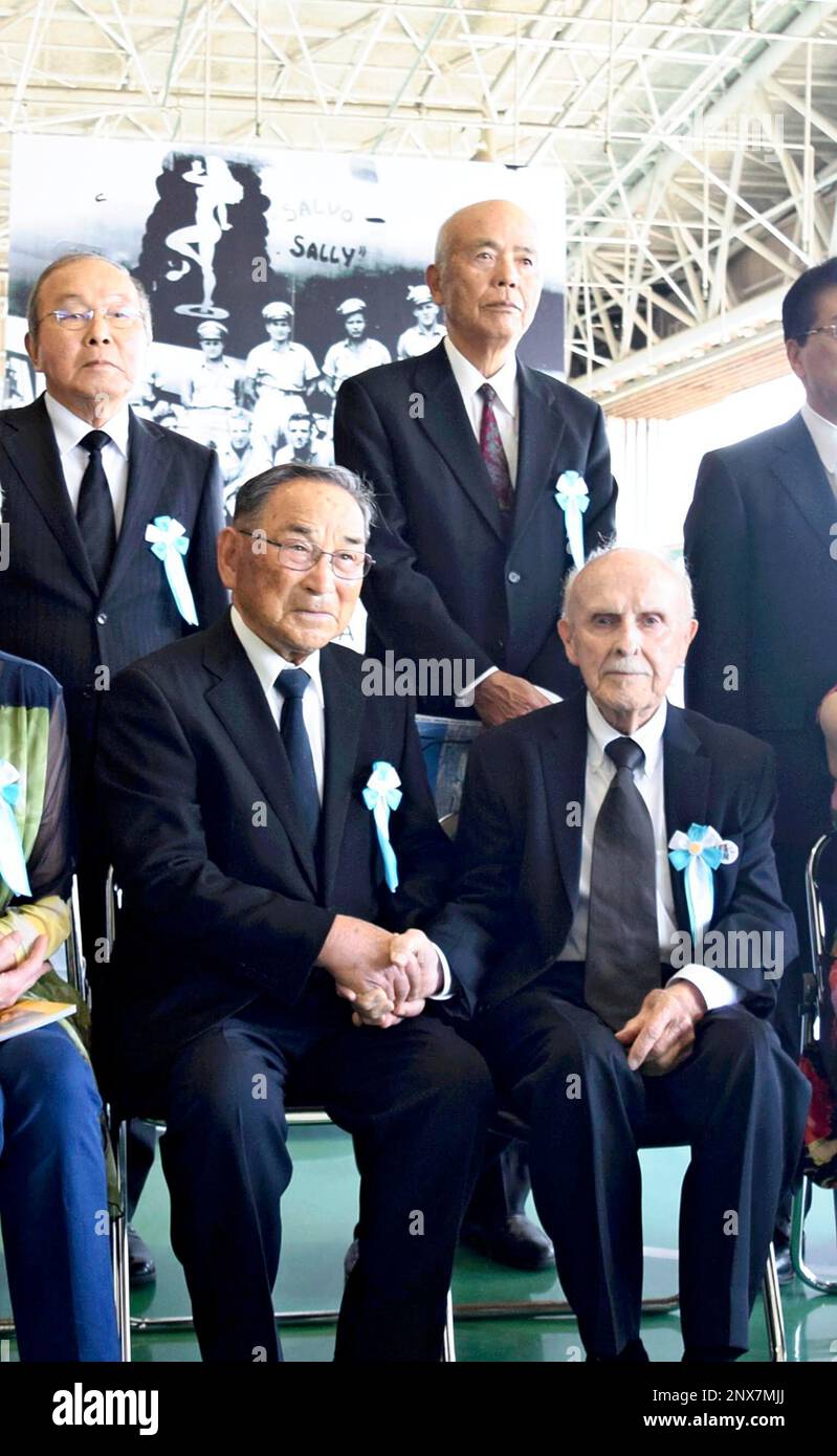 B-29 called Salvo Sally's survived crewman Jack B. Cannon (front row R) shakes hands with former ...