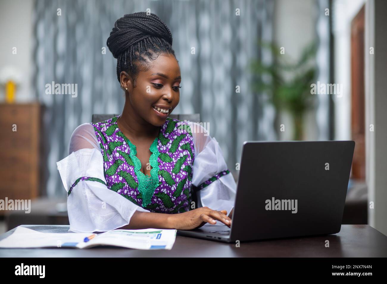 African female university student doing homework, studying online ...