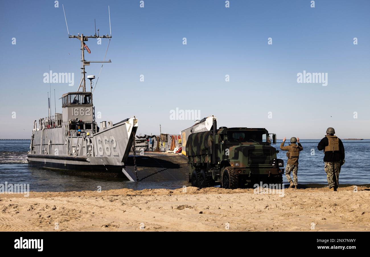 U.S. Sailors with Beachmaster Unit Two, load a Landing Craft Utility ...