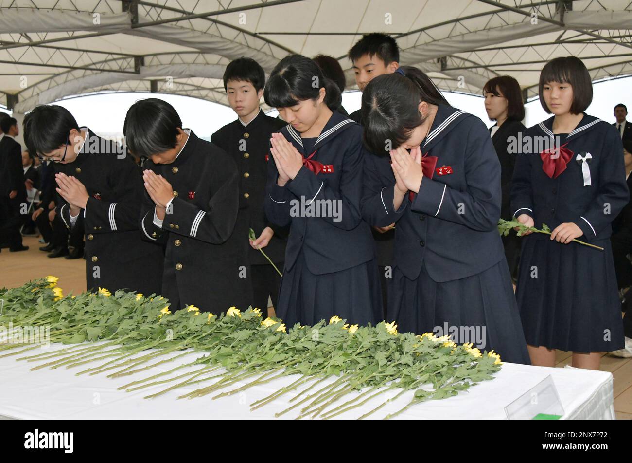 About 700 people including patients offer flowers and pray for the ...