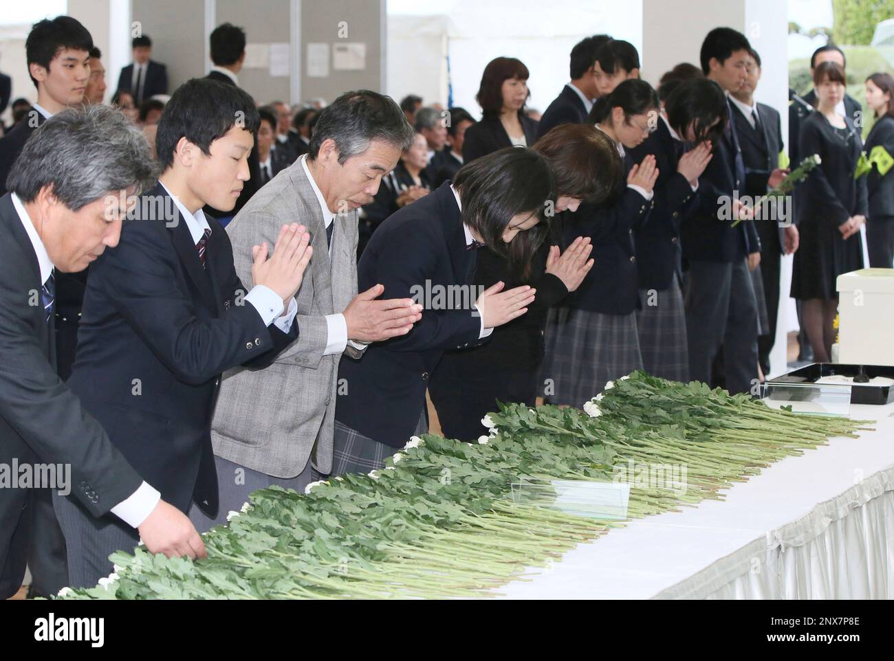About 700 people including patients offer flowers and pray for the ...