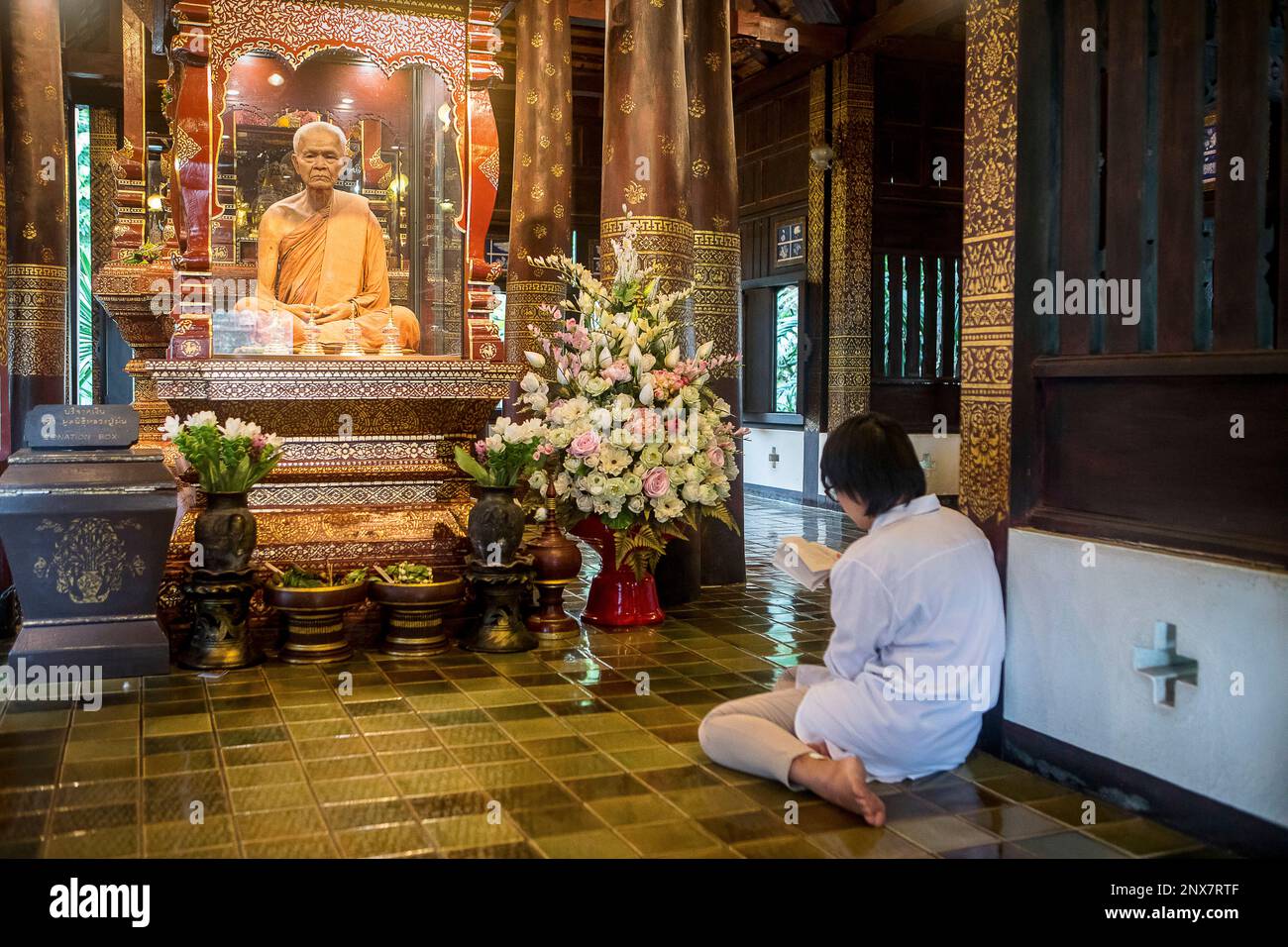 Believer praying, monk statue, in Wat Chedi Luang temple, Chiang Mai ...