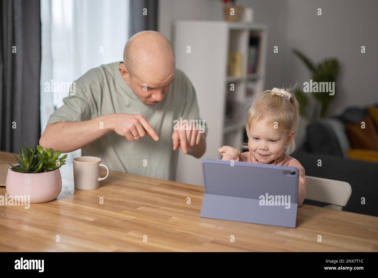 People with cochlear implant system. Kid study to hear with her father ...