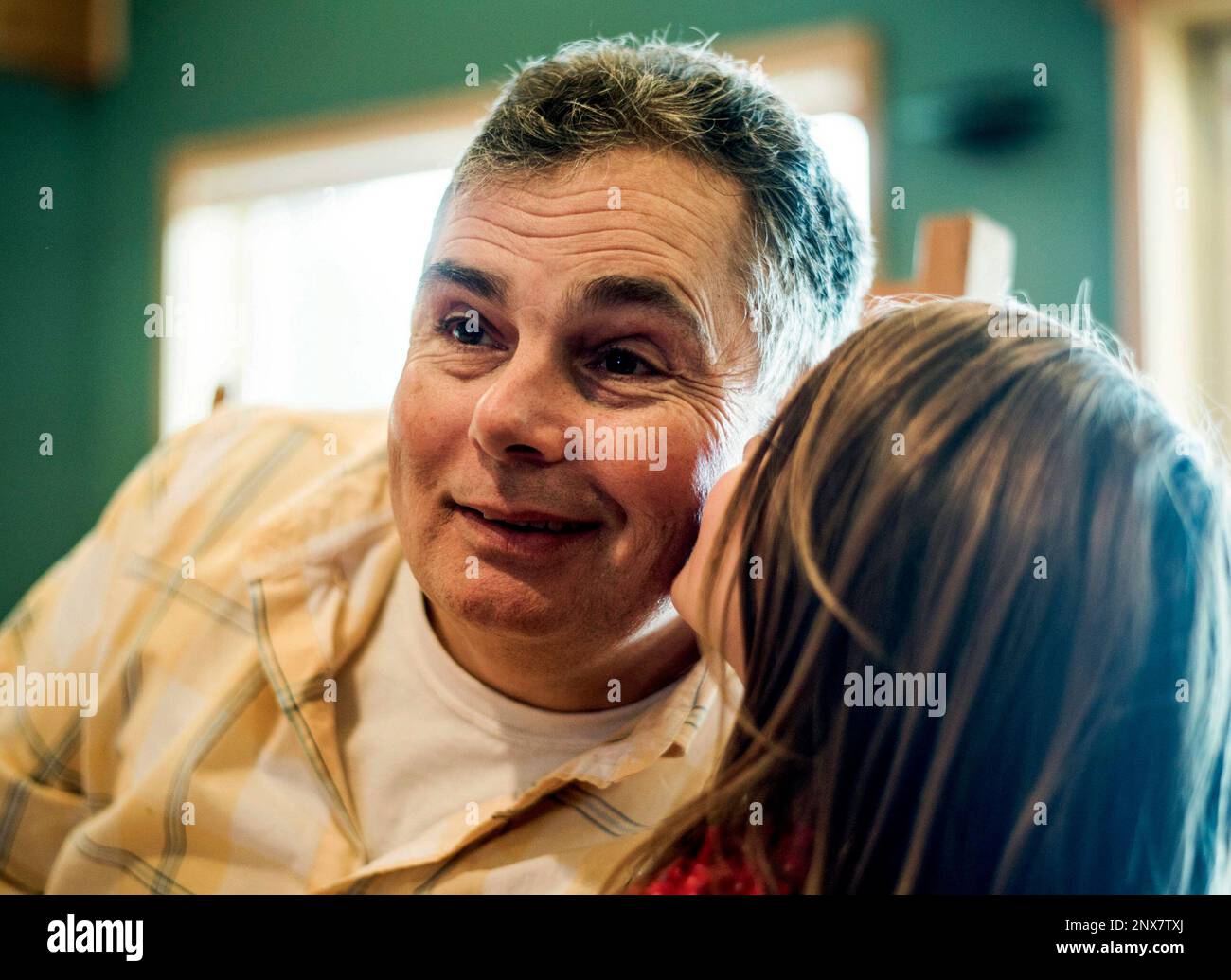 In this Jan. 12, 2017 photo, Bill Putman gets a kiss on the cheek from ...