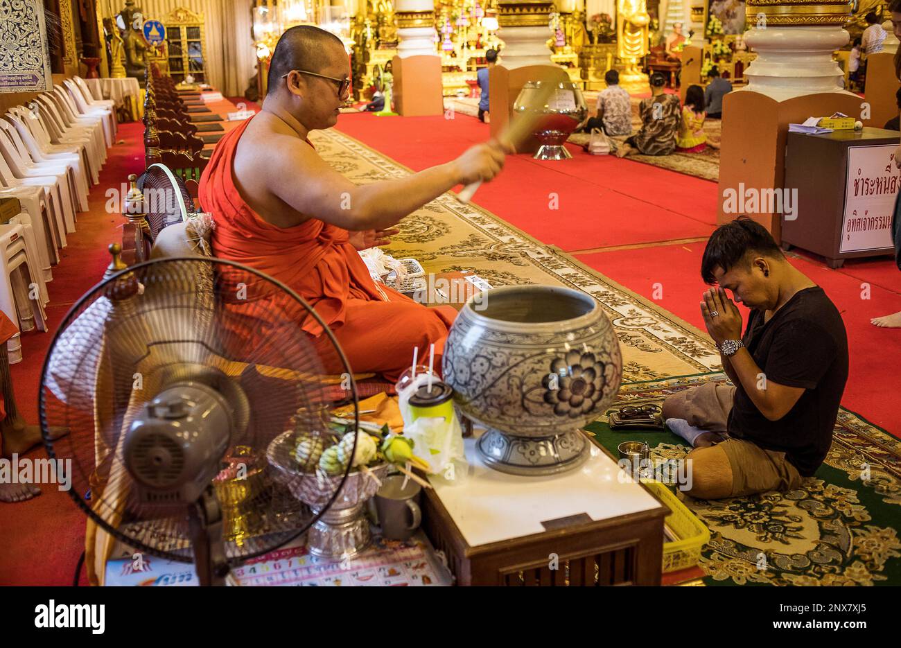 Monk blessing a man, in Wat Phra Singh temple, Chiang Mai, Thailand ...