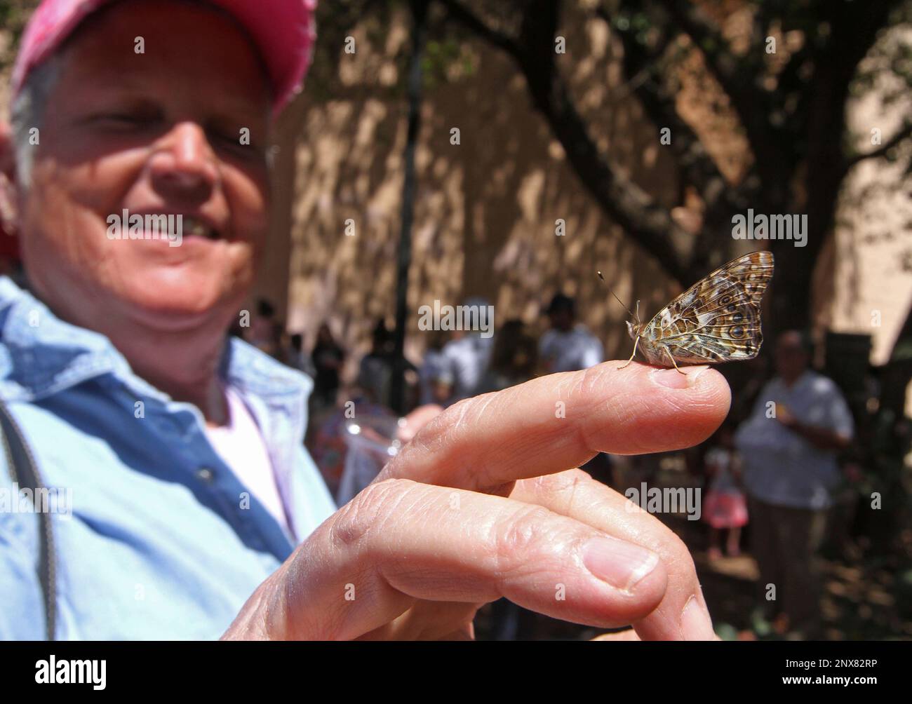 Karen Choate holds a butterfly she is releasing in remembrance of her ...