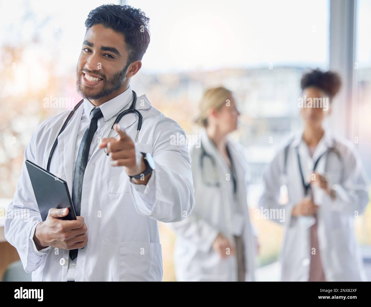 Indian doctor, portrait and healthcare worker pointing at you for we ...