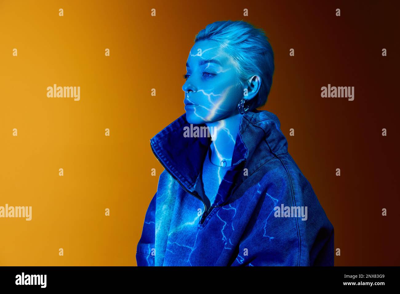 Lightning. Portrait of young blonde girl with abstract neon stripes on ...