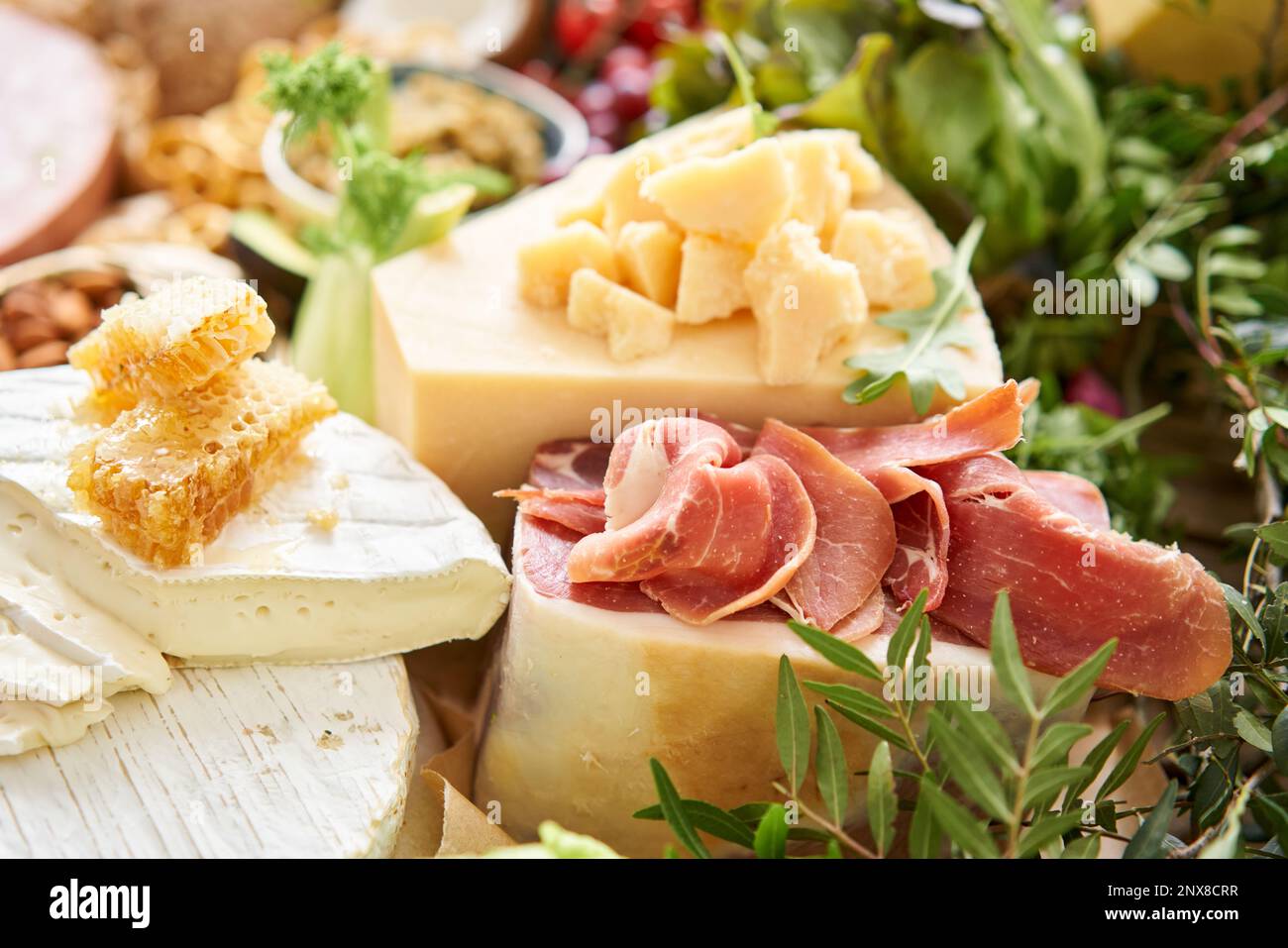 Parmesan cheese with honey close-up. Table full of mediterranean ...