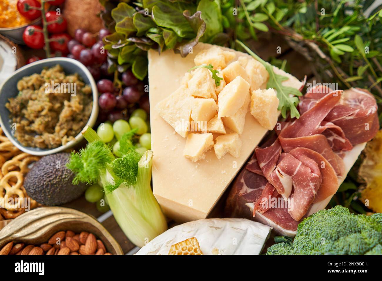 Parmesan cheese with honey close-up. Table full of mediterranean ...