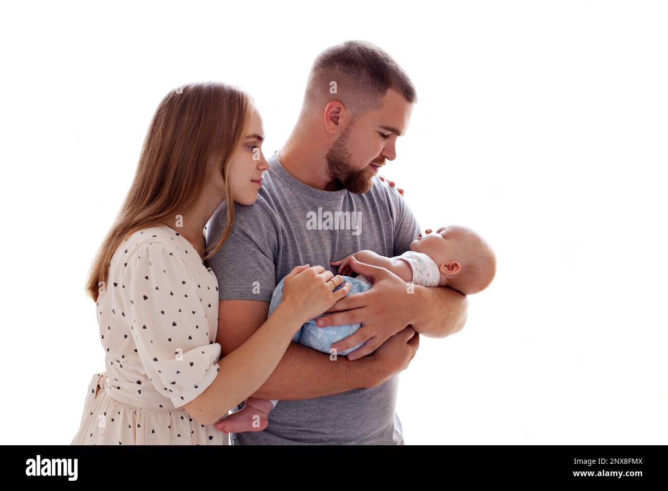 Happy family with newborn baby. Beautiful mom and dad hold sleeping ...