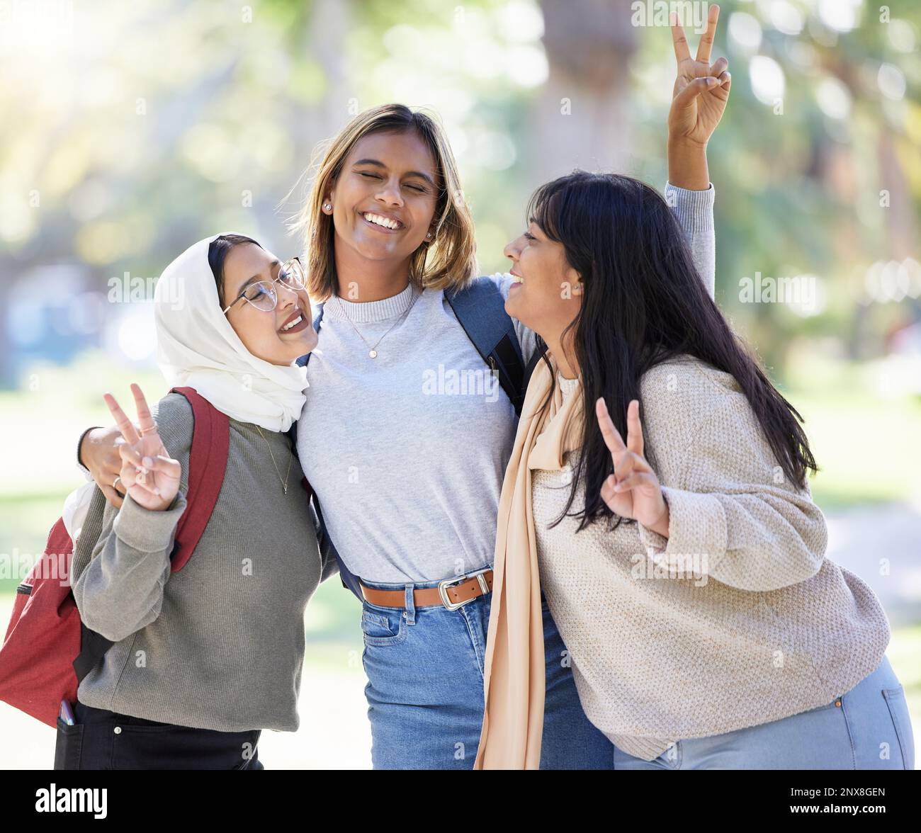 Women, friends or peace sign in nature park, garden or school campus ...