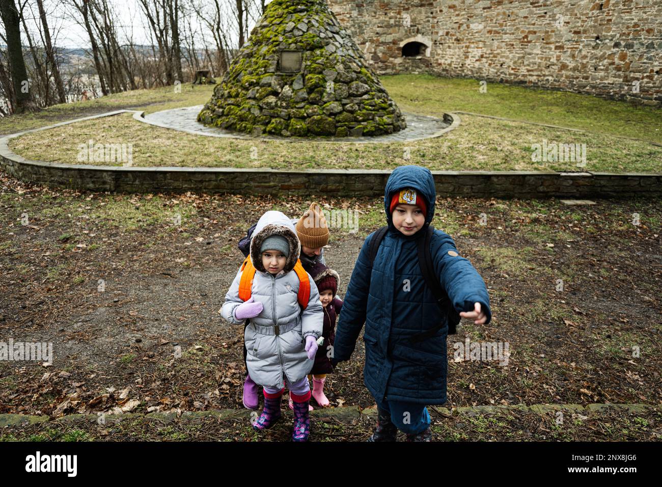Mother and children walking in forest, noticed an animal burrow Stock ...