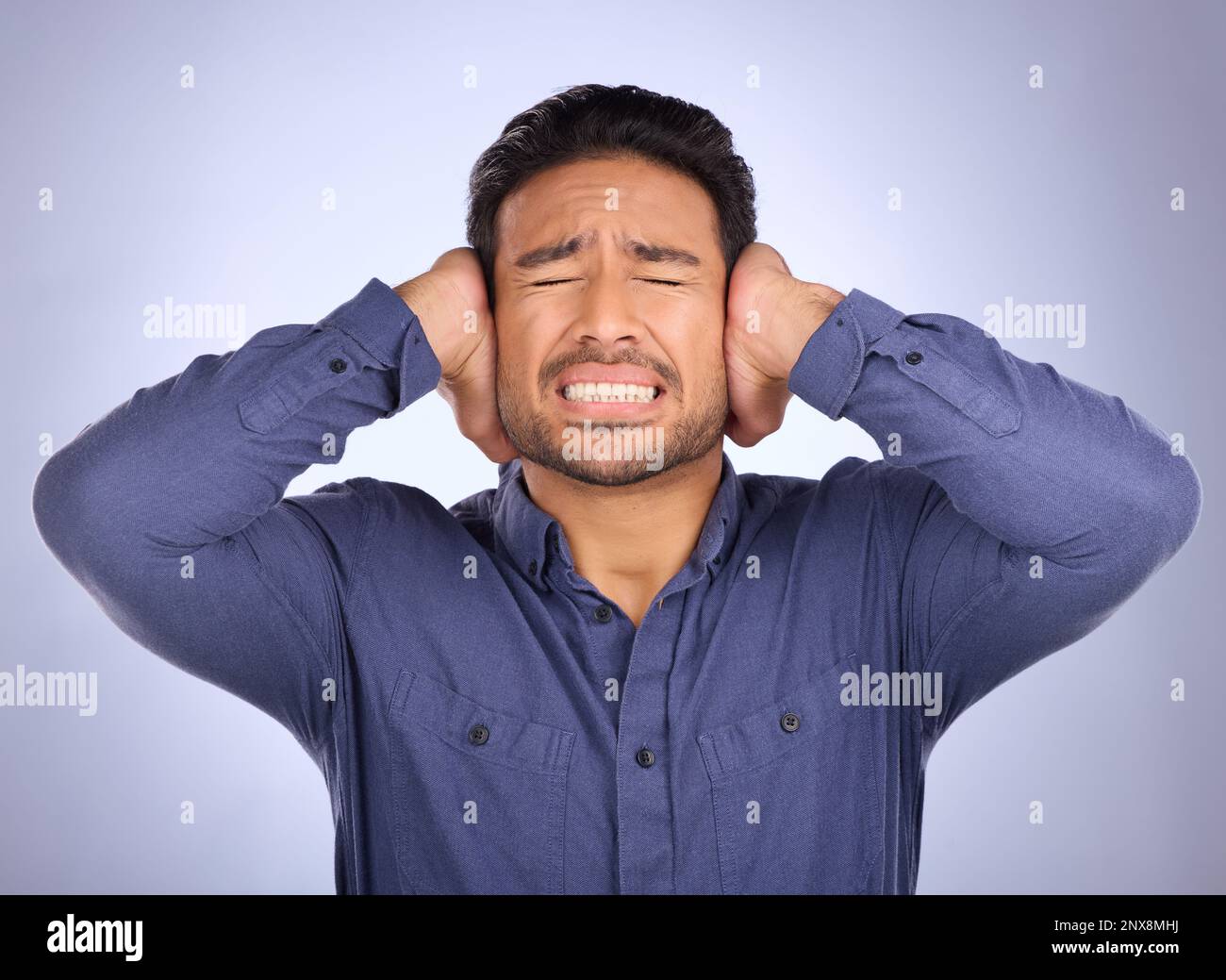 Stress, noise and man closing his ears in studio isolated on a gray ...