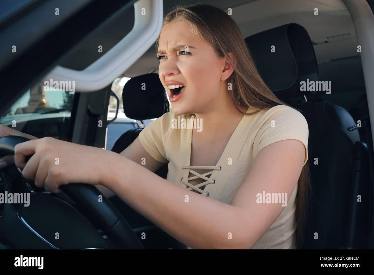 Emotional woman in car. Aggressive driving behavior Stock Photo - Alamy