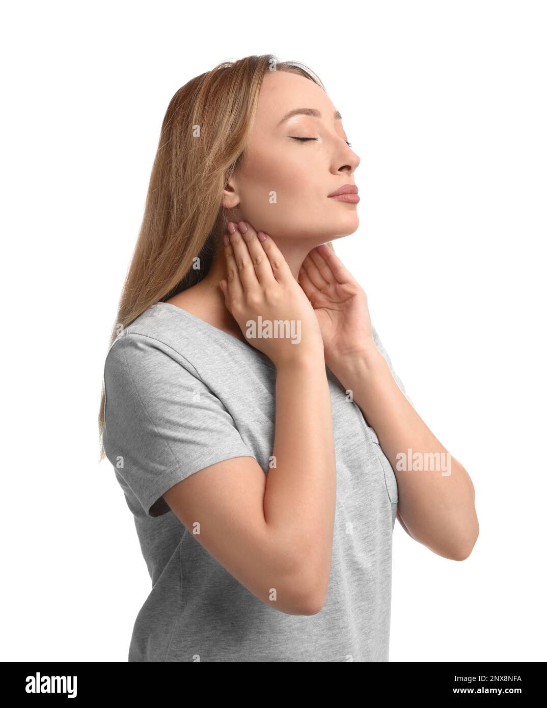 Young woman doing thyroid self examination on white background Stock ...