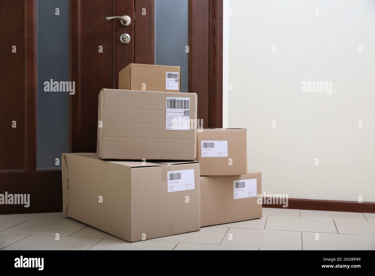 Stacked parcels near door on floor, space for text. Delivery service ...