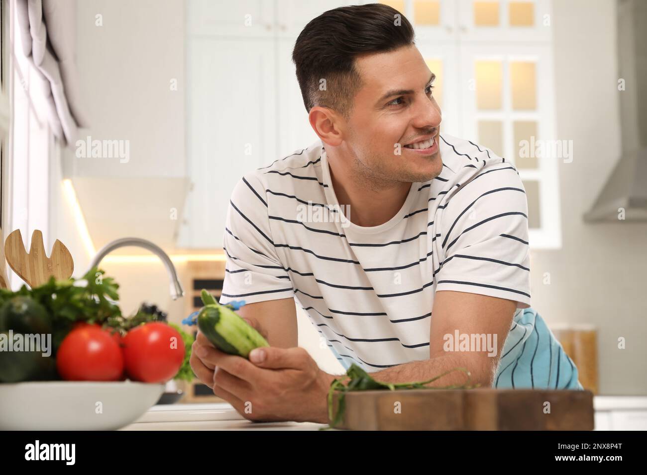 Man peeling cucumber home hi-res stock photography and images - Alamy