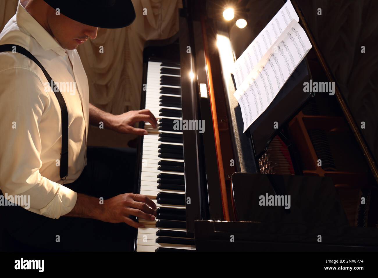 Man playing grand piano indoors. Talented musician Stock Photo - Alamy